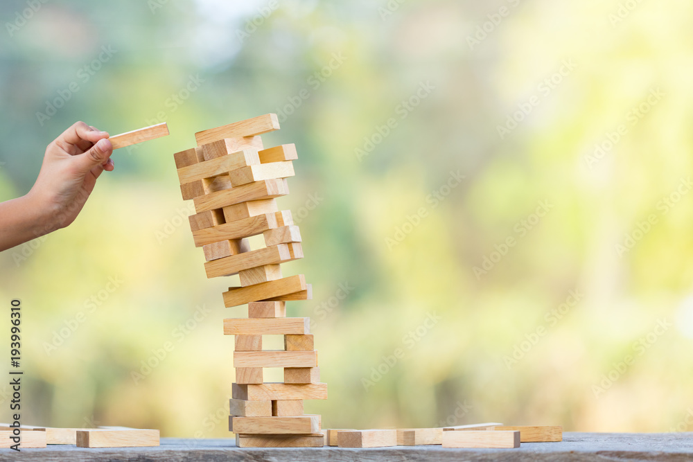 The jenga game ,tower stack from wooden blocks toy and hand take on ...