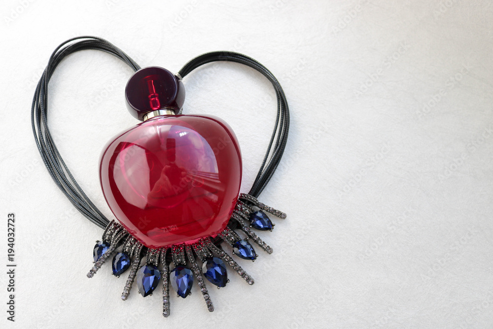 Red beautiful glass transparent bottle of female perfume lying on black ...