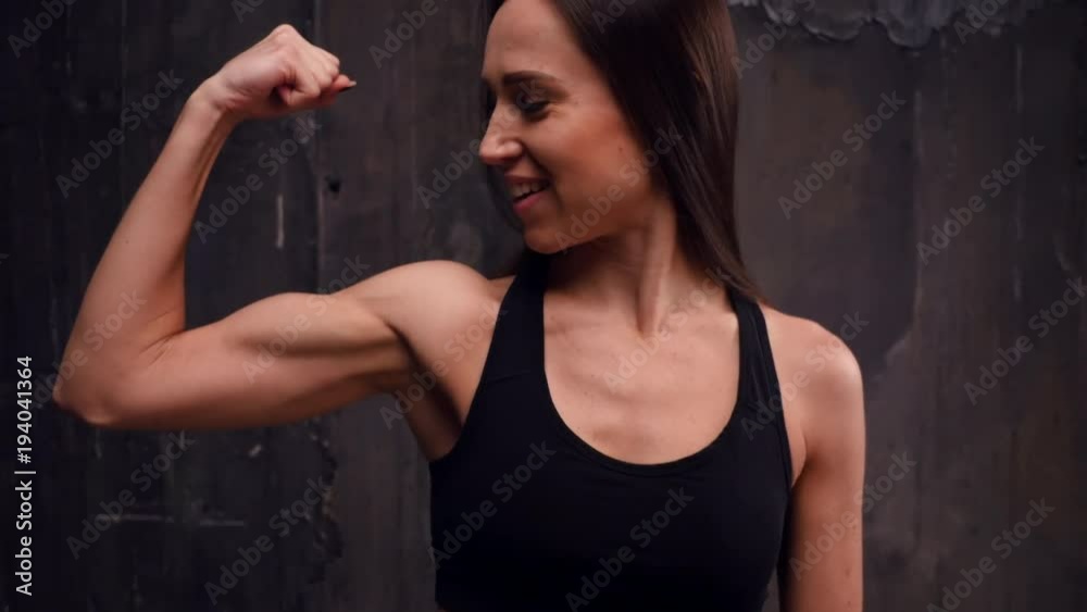 Woman with perfect biceps and triceps demonstrating muscles Stock Video ...