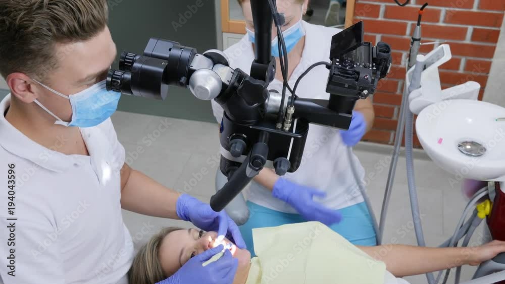 medical personnel use dental microscope to examine oral cavity of ...