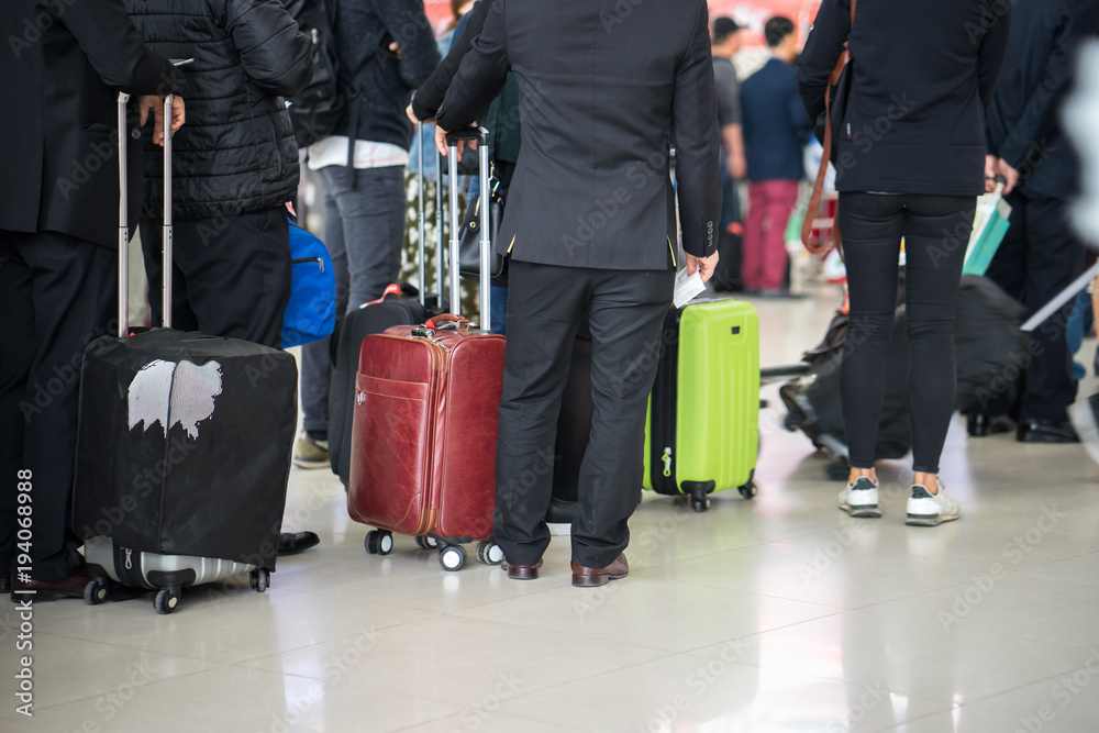 Queue of Asian people waiting at boarding gate at airport. Closeup ...