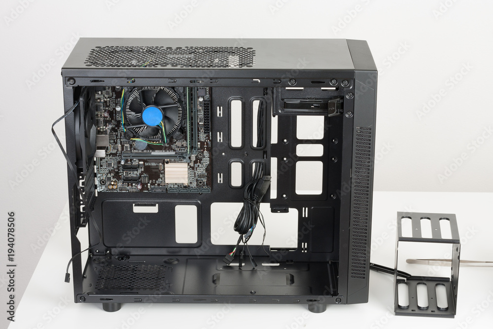 Building of PC, ATX motherboard inserted to black computer midi tower ...