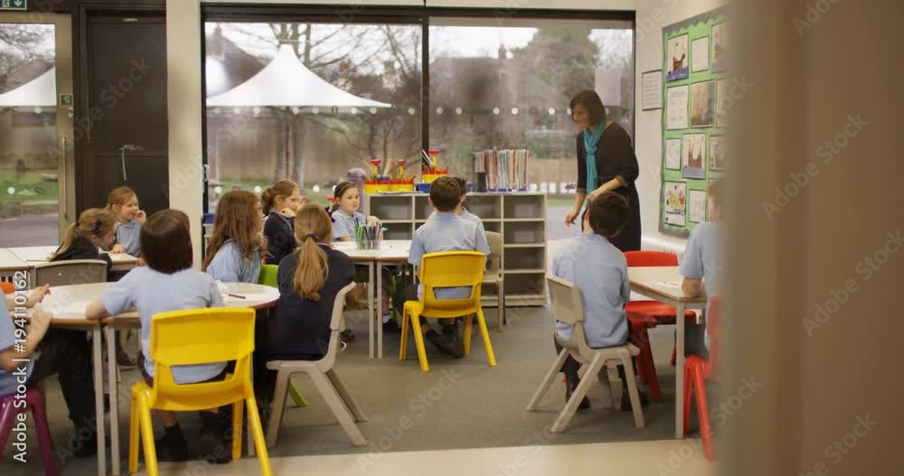 4K Elementary school children listening attentively to their teacher in ...