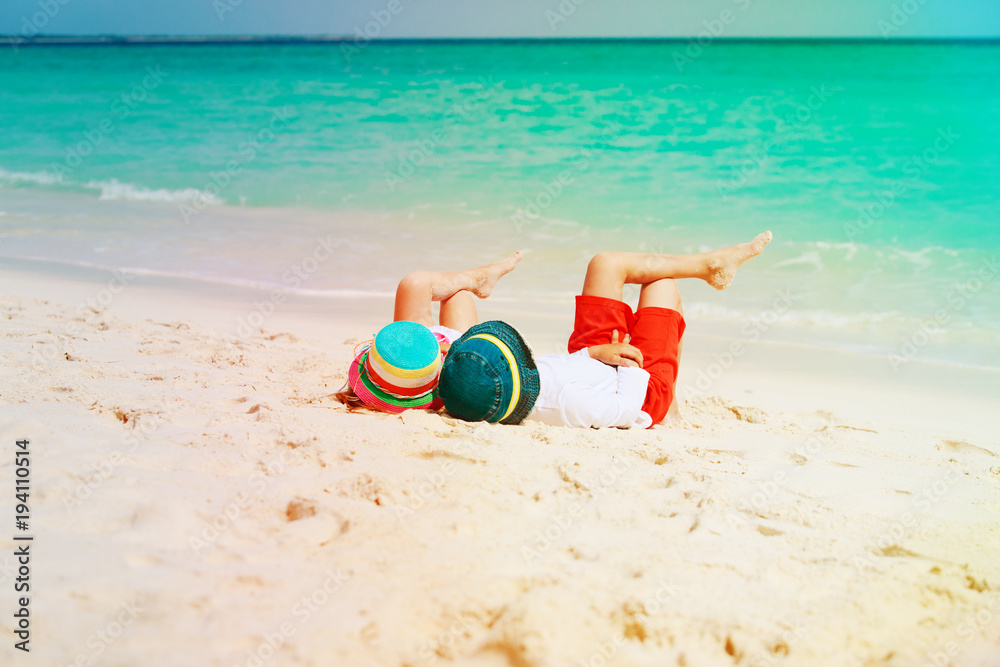 little boy and girl relax on tropical beach Stock Photo | Adobe Stock