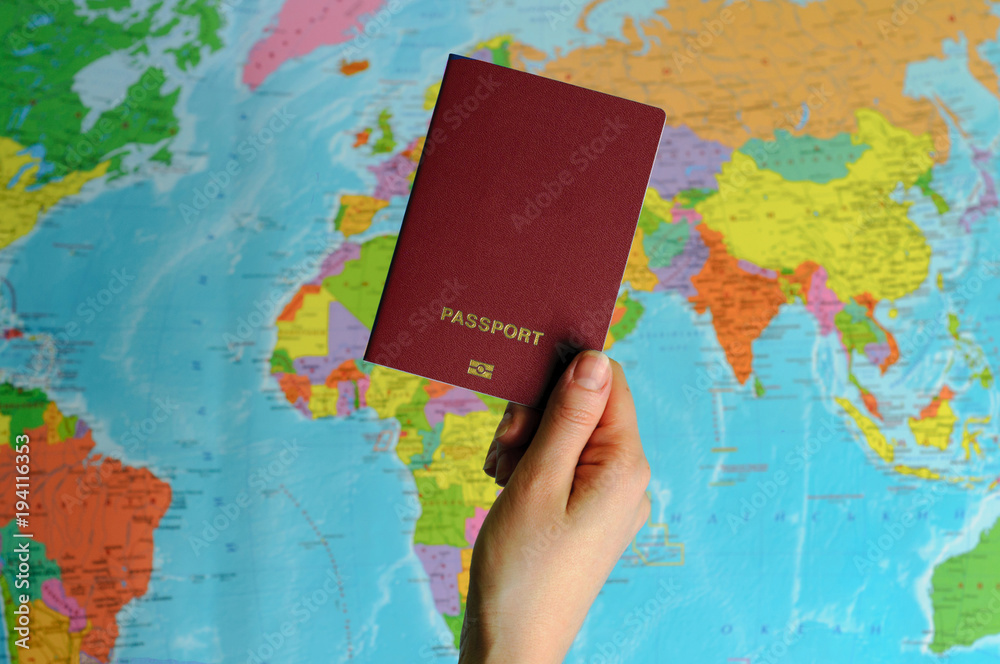 red passport on the world map in women's hands Stock Photo | Adobe Stock