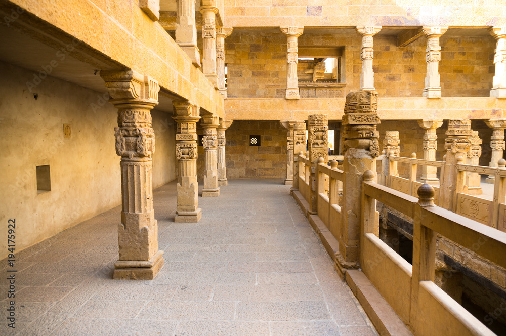 Interiors of a sandstone fort with carved pillars and railings made of ...