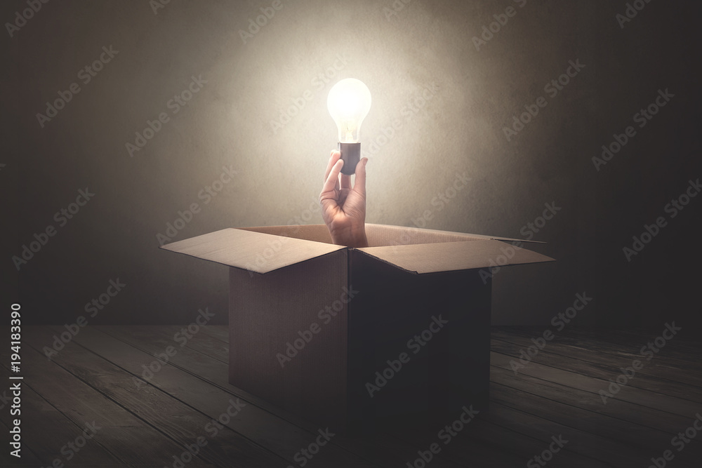 hand holding light bulb coming out from a paper box Stock Photo | Adobe ...
