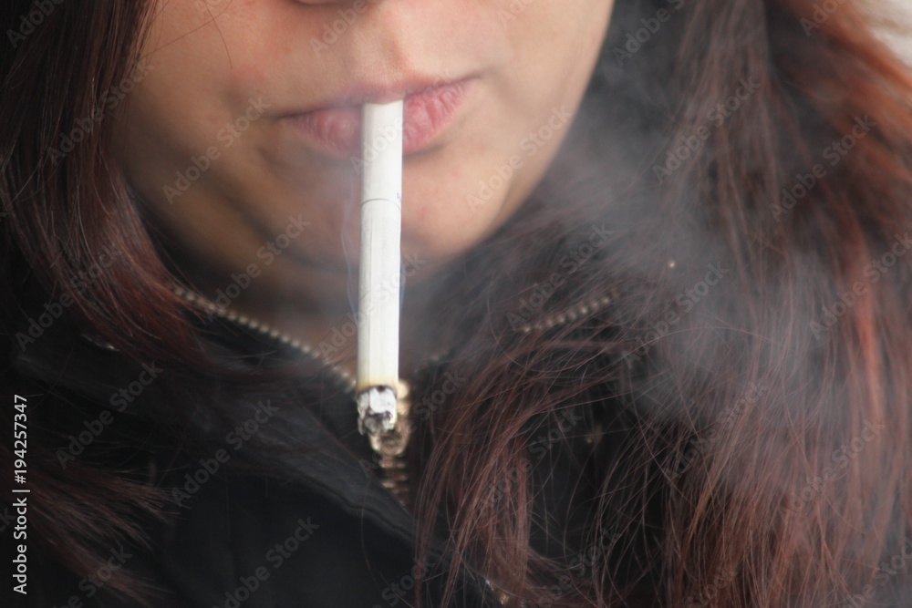 Cigarettes. Young women smoke cigarettes. Smoking cigarette . Young ...