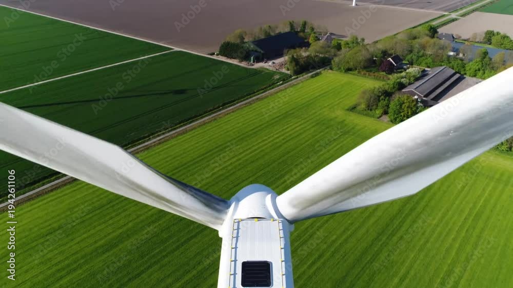 Aerial top down view wind turbine in polder landscape moving above the ...