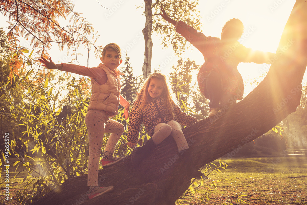 Happy little girls on tree. Stock Photo | Adobe Stock
