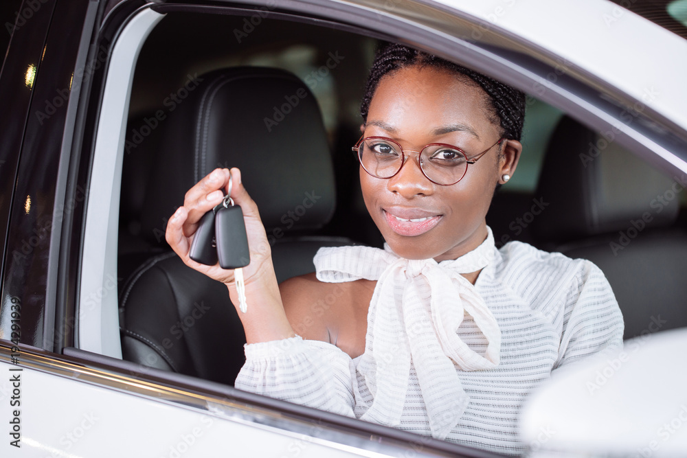 Beautiful young mixed race black African American woman driving car and ...