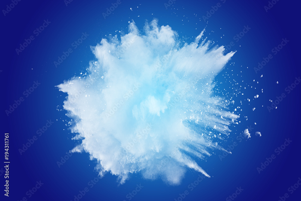 Abstract blue dust explosion on navy blue background. Abstract blue ...