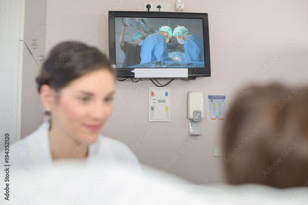 senior female patient watching tv in hospital bed Stock Photo | Adobe Stock