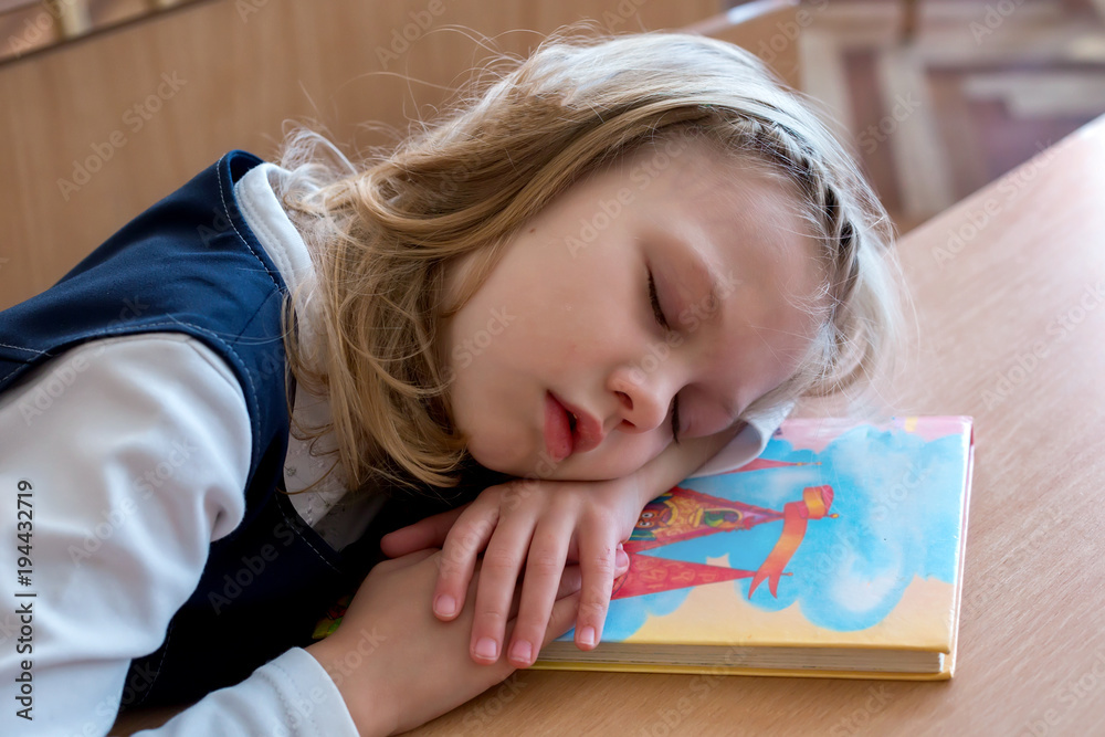 School girl sleeping at the school is sleep at the desk. Student. Pupil ...