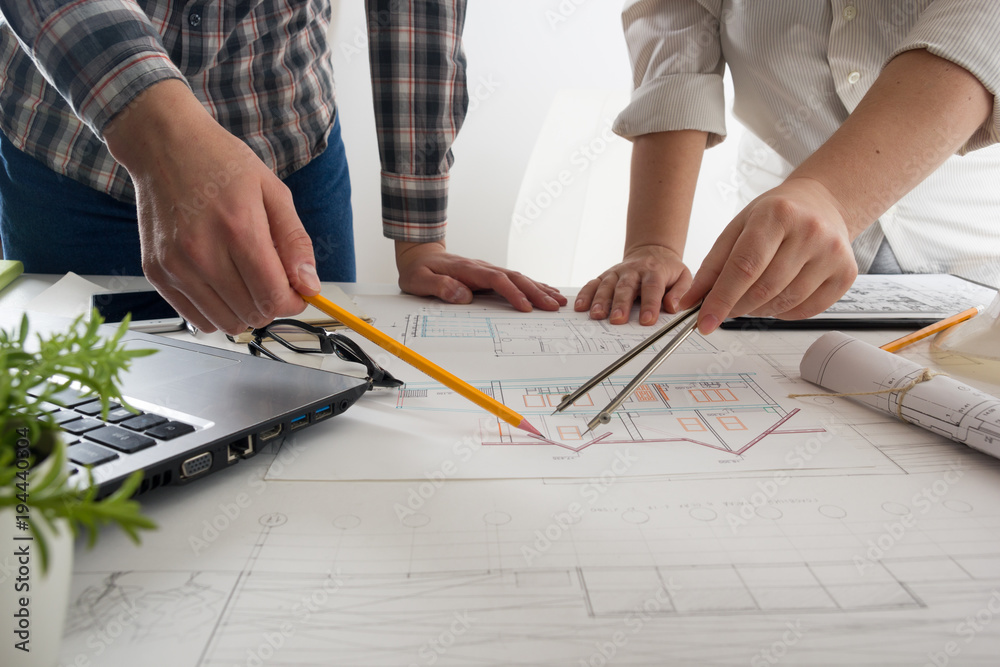 Architects working on blueprint, real estate project. Architect ...