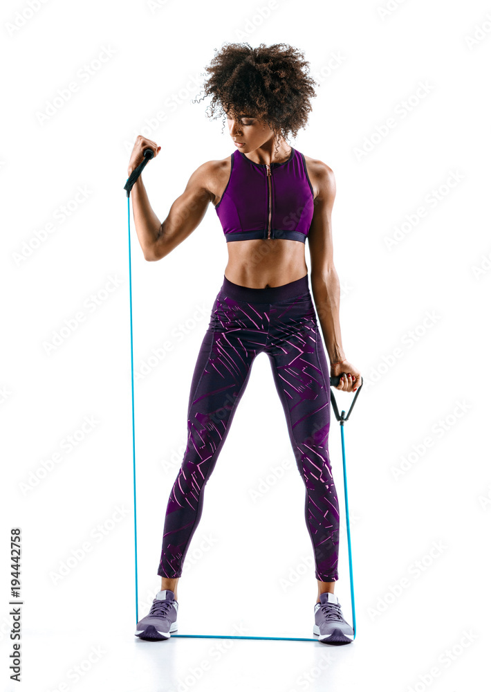 Athletic girl performs exercises using a expander. Photo of young girl ...