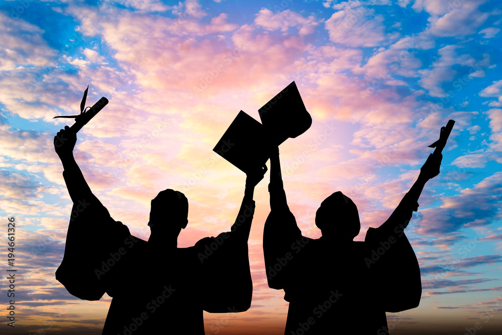 Silhouette of Student Graduation. They are seeing sunset. They are ...