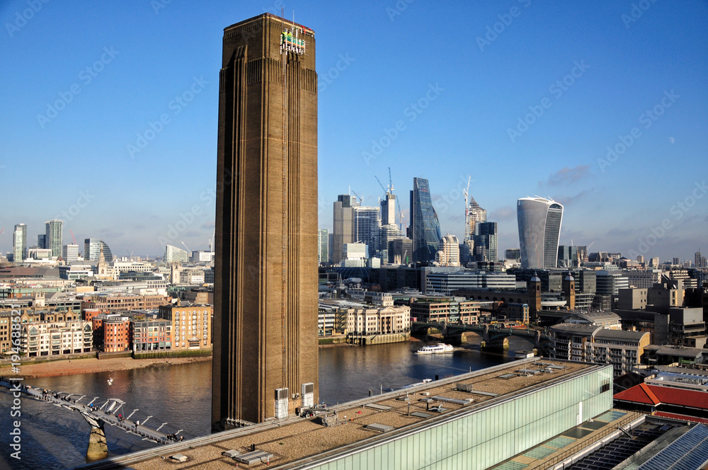 Tate modern famous chimney with the business district of London in the ...