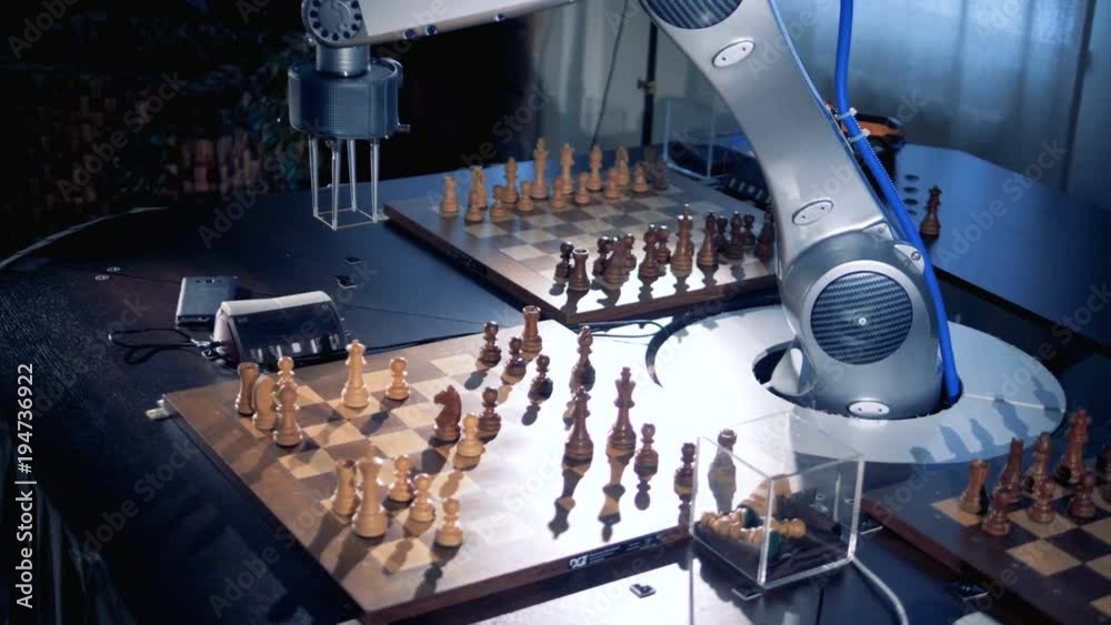 A robotic arm is moving chess pieces and pressing the chess clock Stock ...