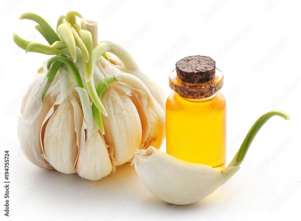 Garlic with essential oil in a bottle Stock Photo | Adobe Stock