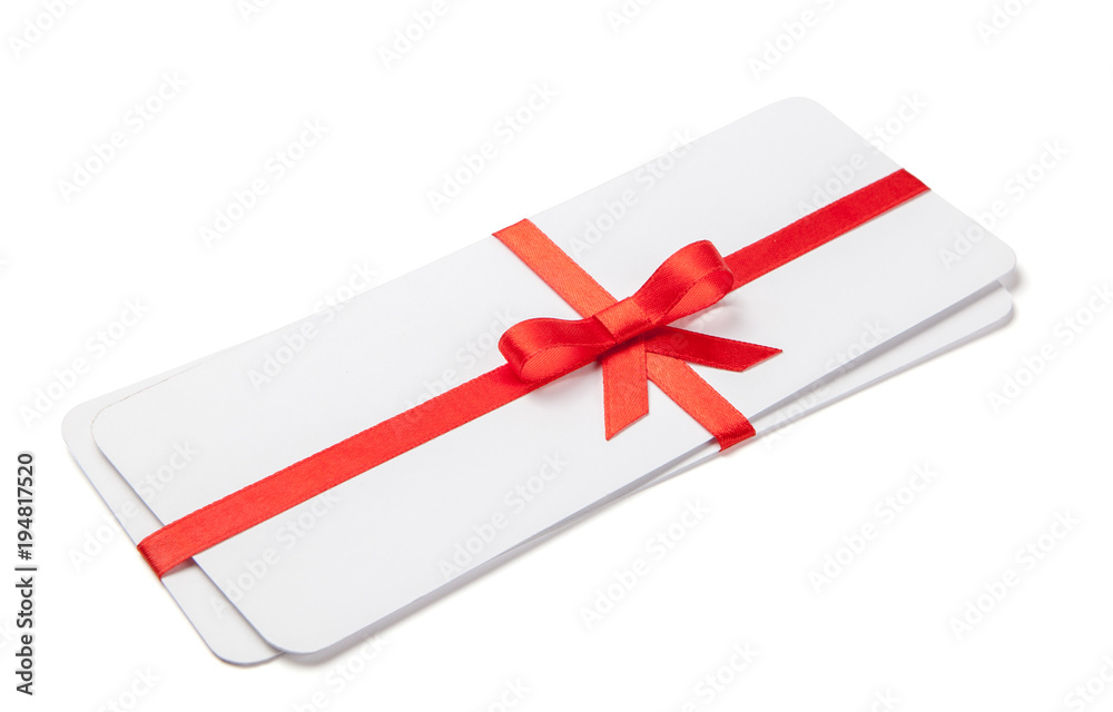 Air tickets as a gift with a red ribbon and bow. Isolated on white ...