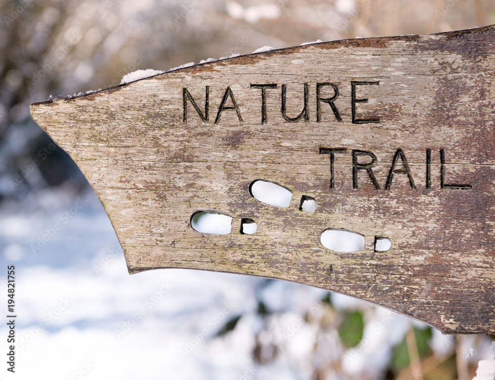 Nature trail sign on a hiking path in a snow covered forest Stock Photo ...