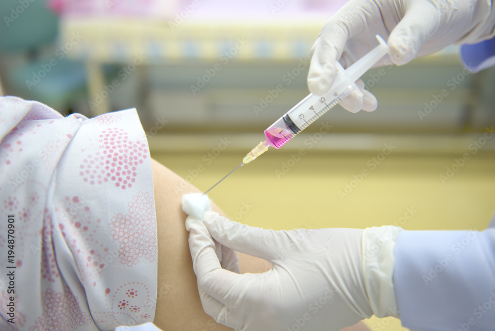 Soft focus nurses are vaccinations to patients using the syringe.Doctor ...