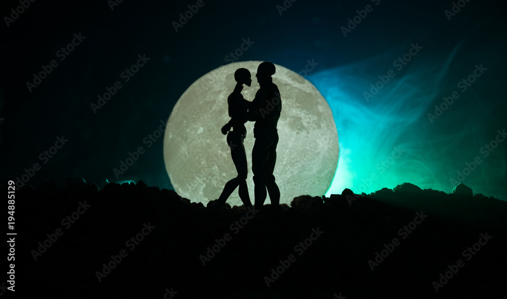 Silhouette of couple kissing under full moon. Guy kiss girl hand on ...