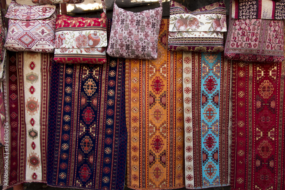 colorful fabrics and other folk products at a roadside stall with ...