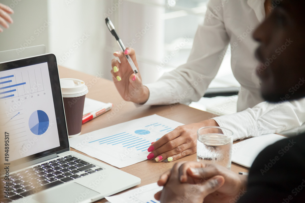 Multiracial team working together on statistics data analysis, diverse ...