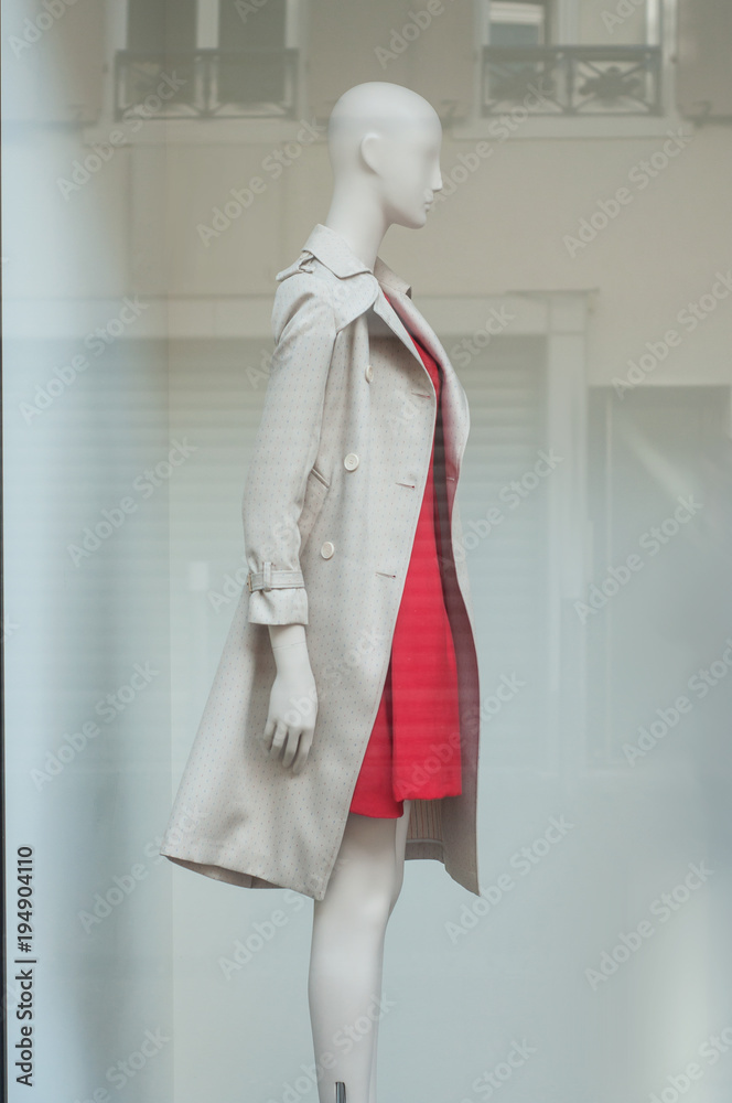 mannequin with red dress and rain coat on fashion store showroom Stock ...