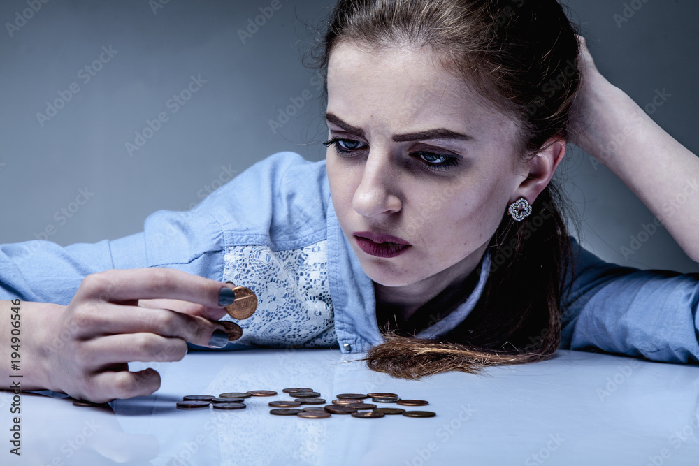 Family debts. Young frustrated and desperate Woman counting small money ...