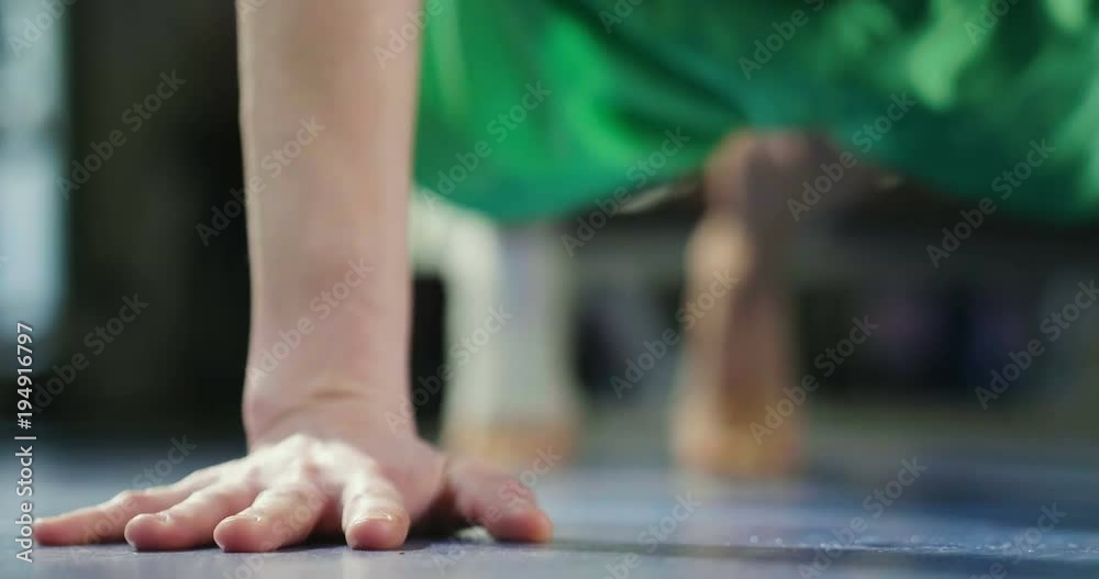 A man trains himself in the gym performing both free-body exercises ...