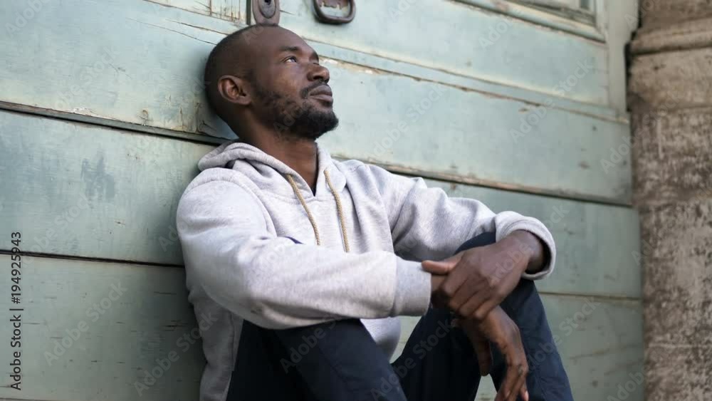 depressed sad young black african man alone sut on the ground vídeo de ...