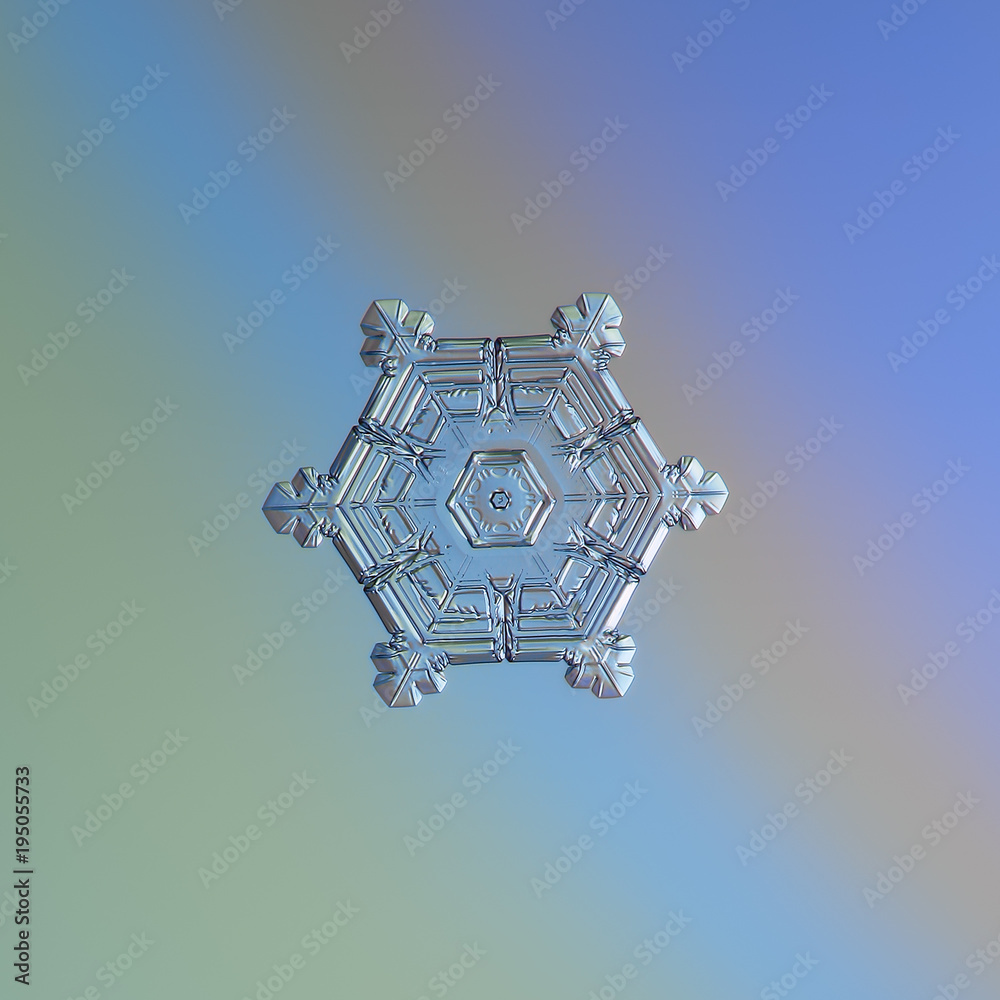 Snowflake glittering on blue gradient background. Macro photo of real ...