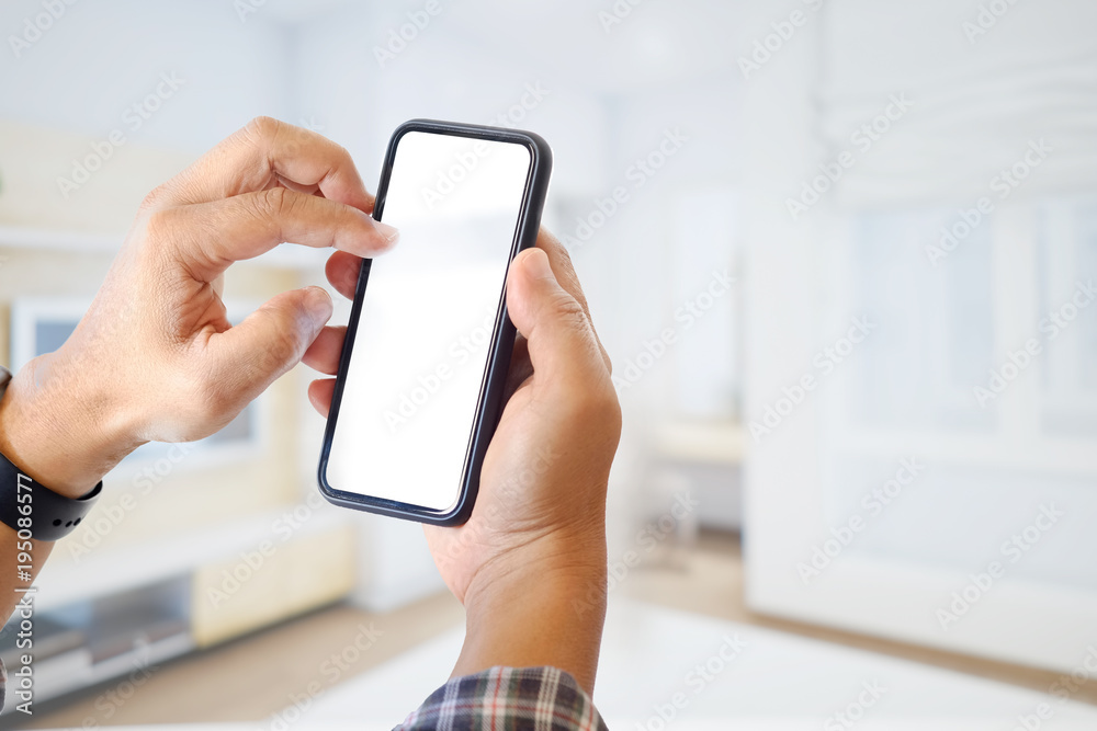 Male hand holding smartphone at office. Blank screen mobile phone for ...