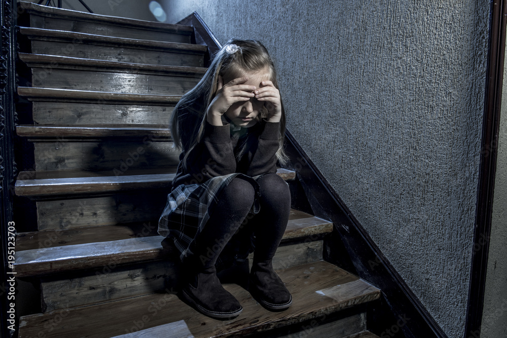 7 or 8 years old sad depressed and worried schoolgirl sitting on ...