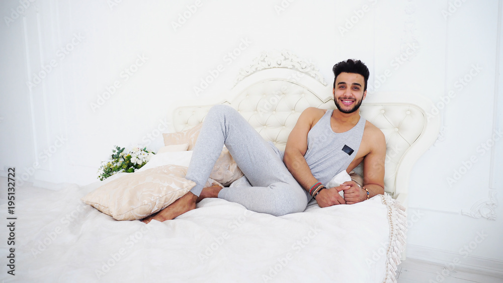 Handsome and Confident Nice Muslim Man in Bed With Knees Bent Legs ...