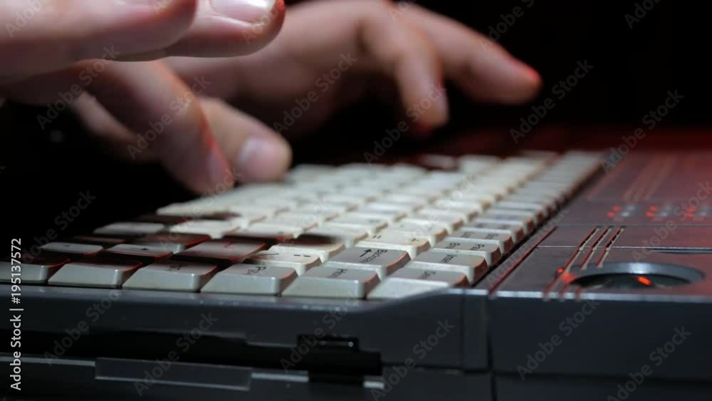 4k Cyber hacker works with old retro laptops at dark room software ...