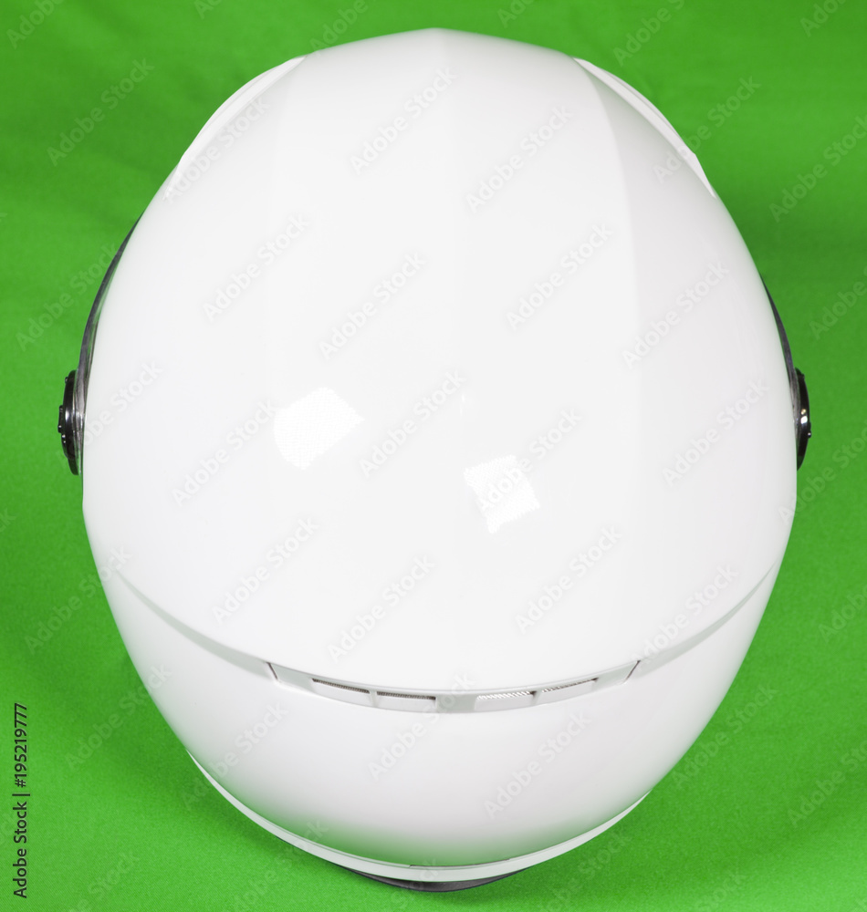 Rear view at full-face riding motorcycle helmet, a green background ...