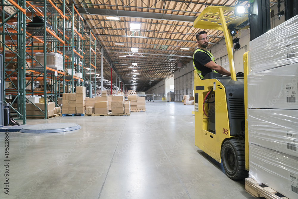 Forklift in a warehouse Stock Photo | Adobe Stock