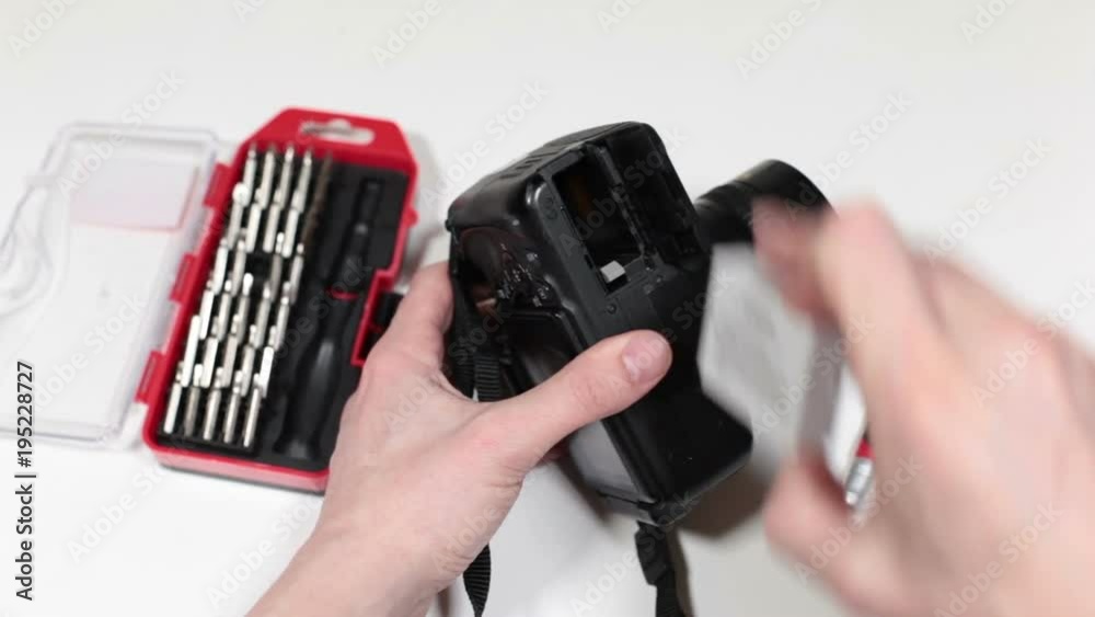 Taking off the battery from dslr camera and disaggregating the body ...