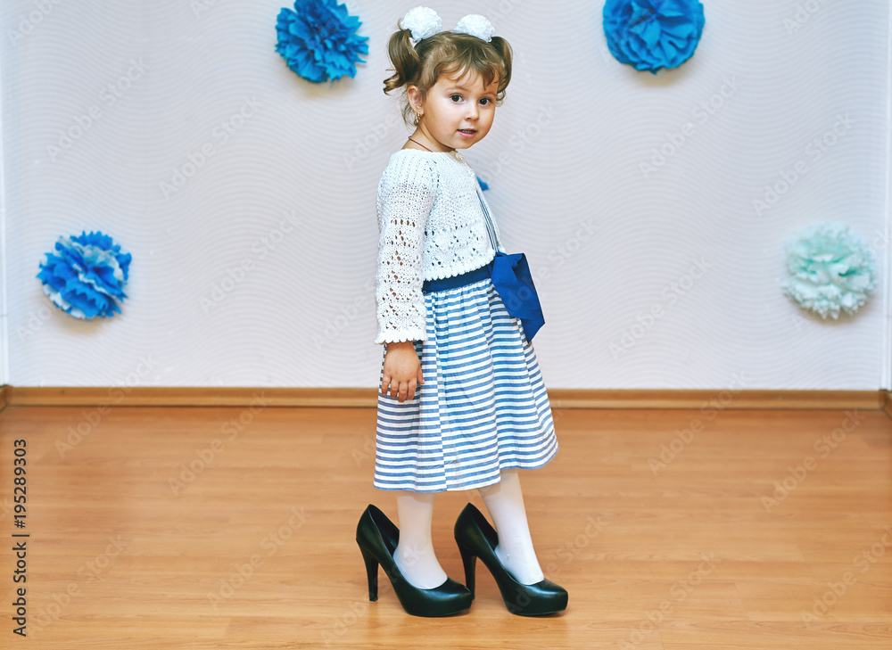 beautiful little girl in mom's shoes Stock Photo | Adobe Stock