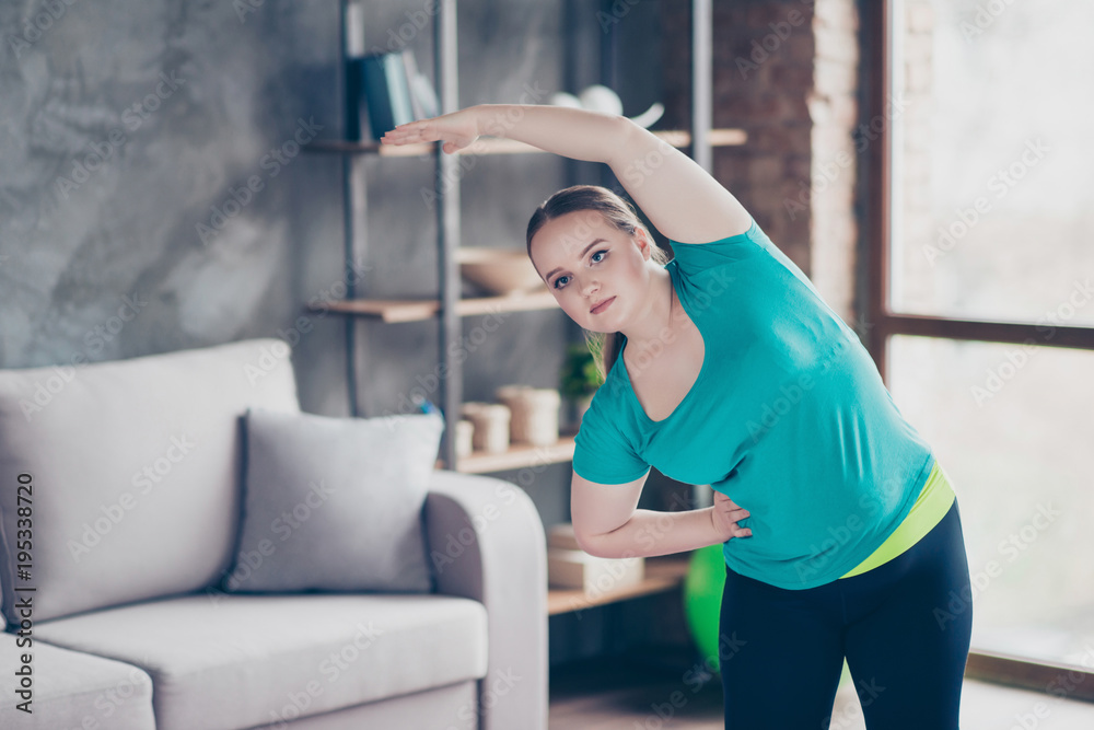 Young woman stretching at home Stock Photo | Adobe Stock