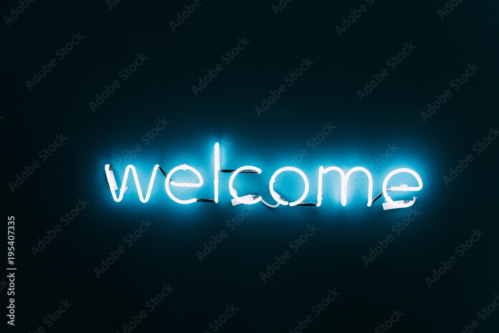 Welcome neon sign on brick wall background Stock Photo | Adobe Stock