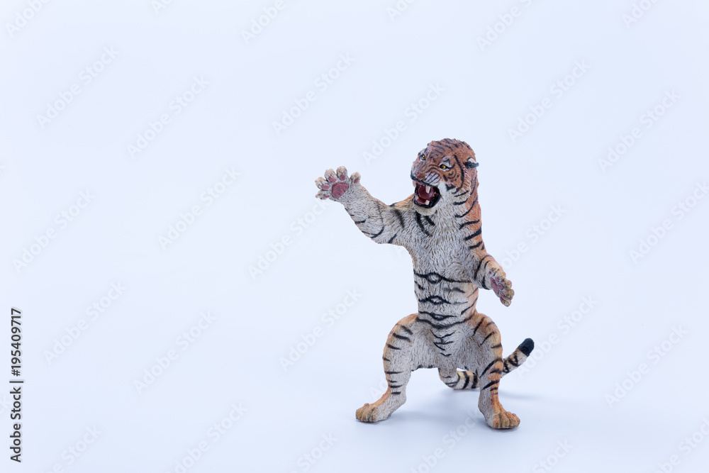 Toy tiger roaring and in attack position with white background - left ...