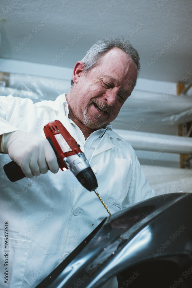 59 year old man working at the fiber workshop Stock Photo | Adobe Stock