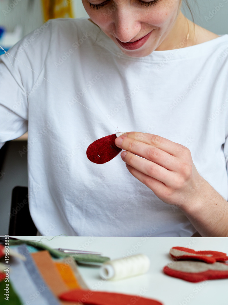 Step-by-step process of manual manufacturing baby crib mobile. Sewing a ...