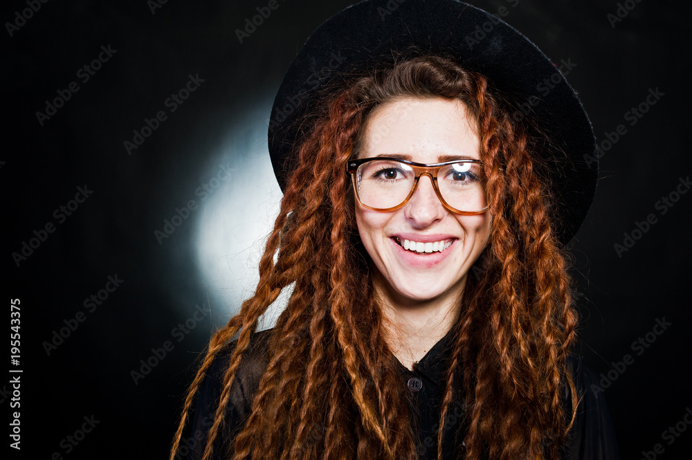 Studio shoot of girl in black with dreads, hat and glasses at black ...