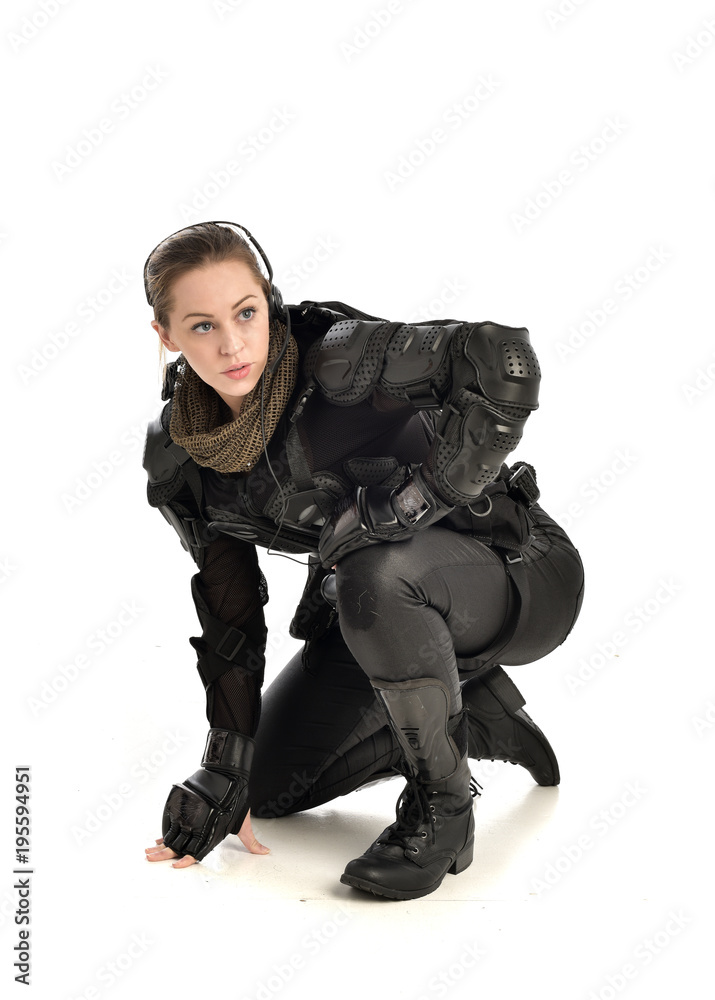 full length portrait of female soldier wearing black tactical armour ...